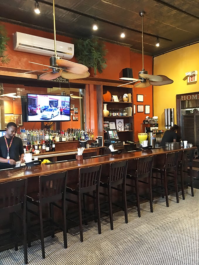 The bar where strangers become friends, united by the universal language of "Have you tried their fried chicken yet?"