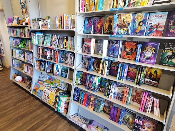 The children's book section stands ready to create the next generation of readers, with colorful spines promising adventures that shape young minds.