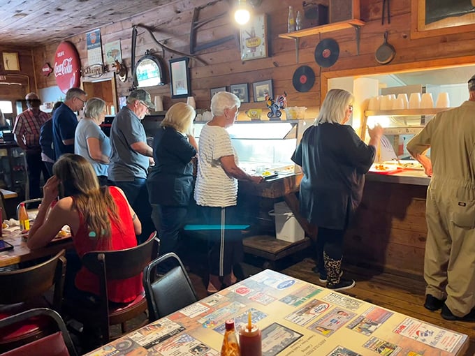 The buffet pilgrimage in progress &ndash; locals lining up for their turn at the altar of comfort food, where patience is always rewarded.