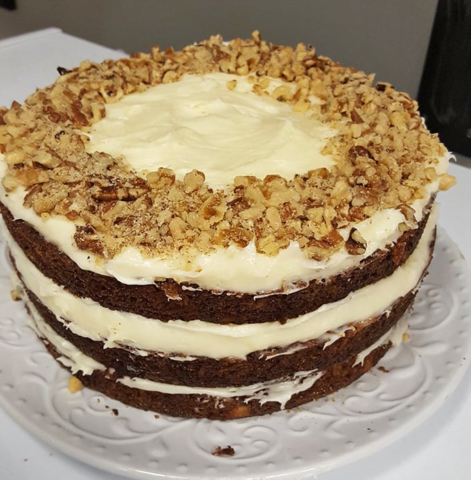 Layer cake standing tall and proud like a monument to butter and sugar, with walnut accents that add just enough crunch to keep things interesting.