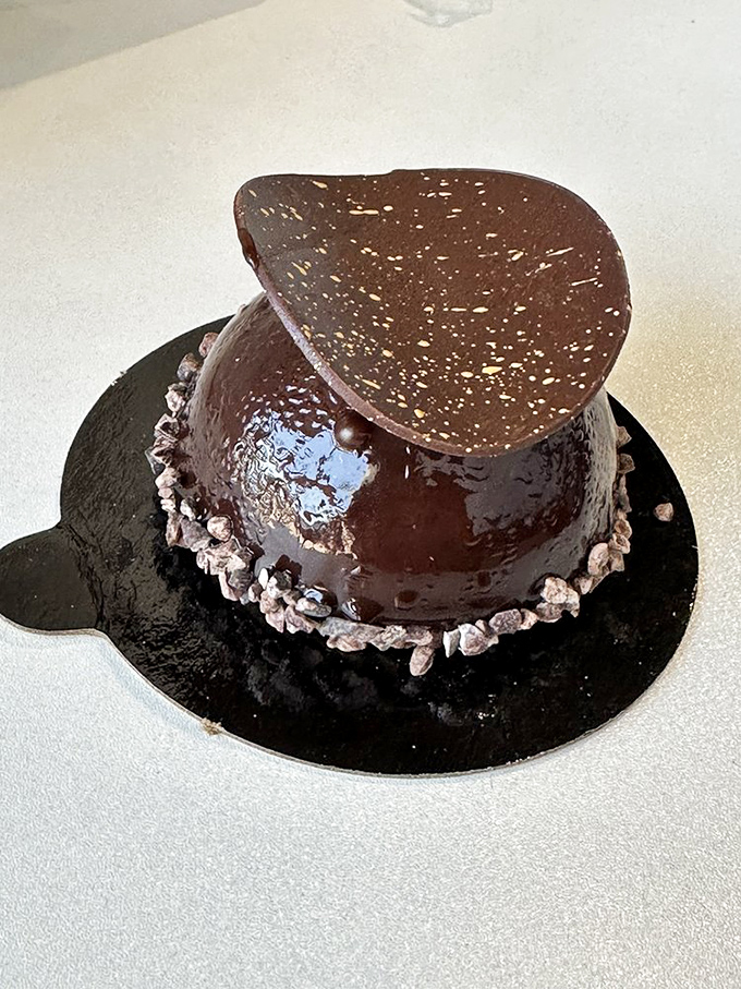 This chocolate dome isn't just dessert—it's performance art. That glossy finish is practically winking at you, daring you to resist.