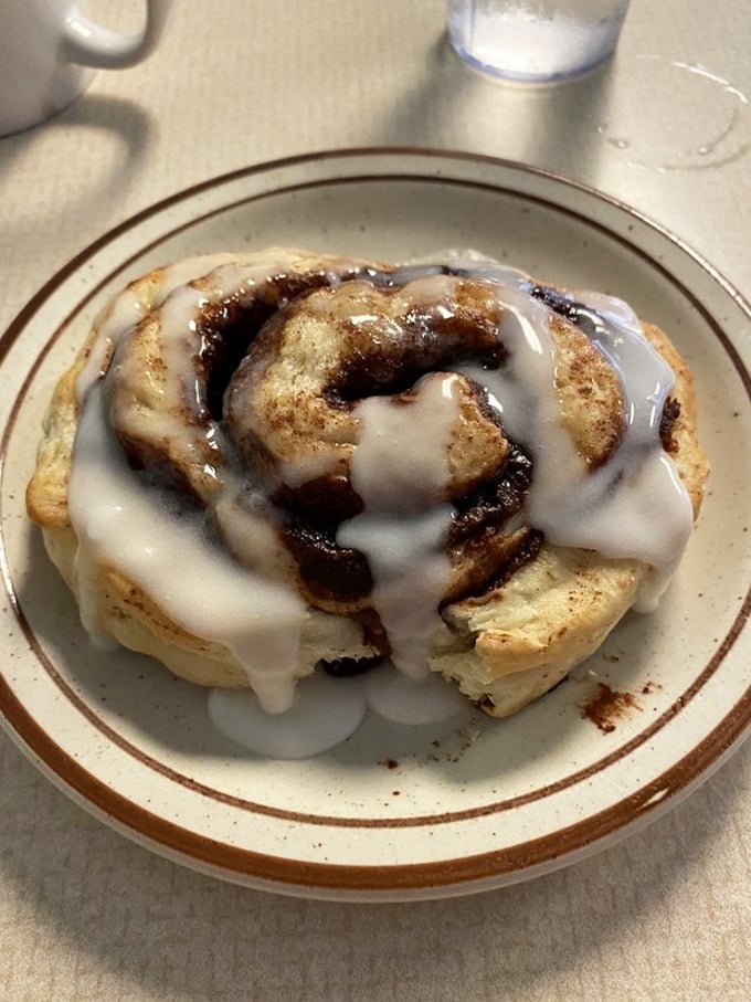 The cinnamon roll that's worth breaking every diet promise you've ever made. This spiral of happiness isn't dessert—it's breakfast's greatest achievement.