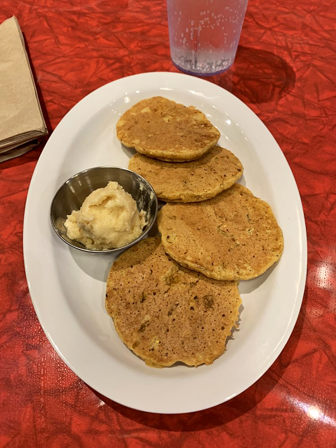 These golden corn cakes with house-made butter aren't just sides&mdash;they're the supporting actors who sometimes steal the scene from the main attraction. 