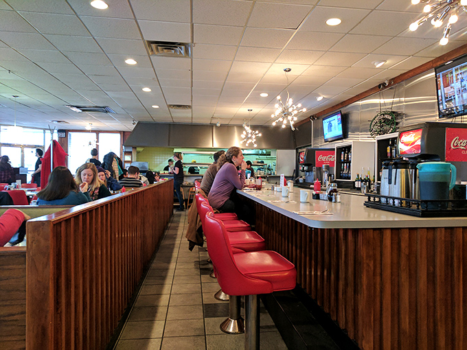 Counter seating: where diner magic happens up close. Those red stools have witnessed countless coffee refills and life-changing breakfast decisions.