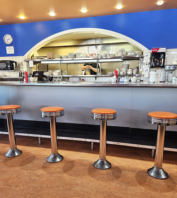 Classic diner counter seating: where solo diners become regulars and the coffee refills flow like conversation. Breakfast theater at its finest.