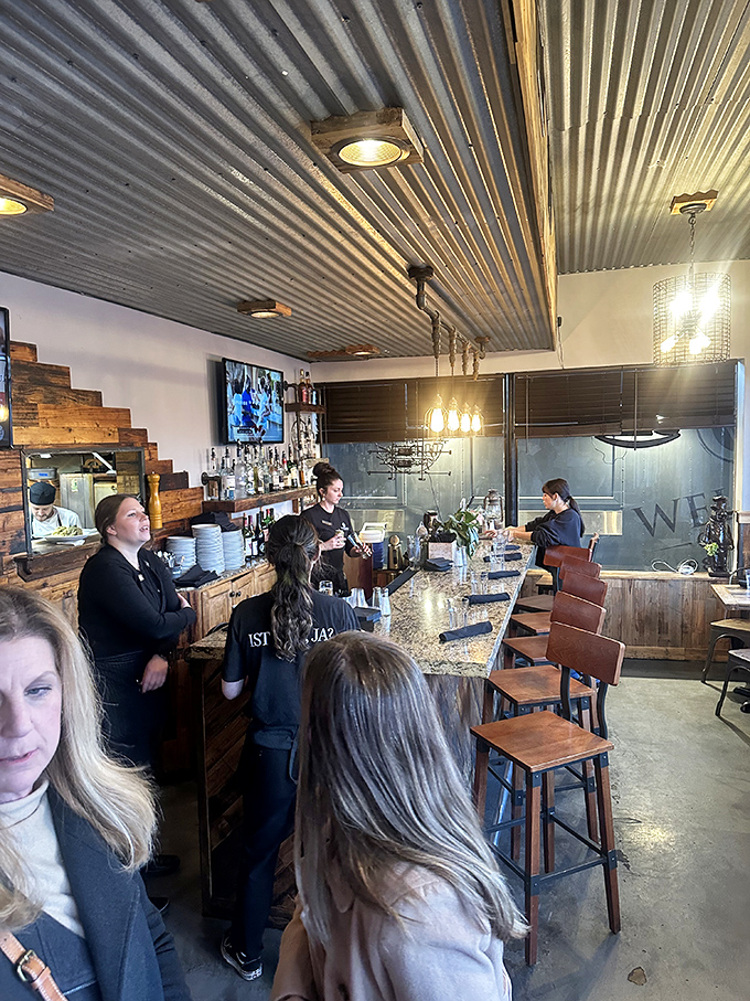 Where the magic happens&mdash;staff orchestrating the dining experience with the precision of a well-rehearsed symphony. The corrugated ceiling adds industrial chic.