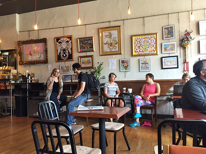 The wall of local art watches over coffee enthusiasts deep in conversation. In the church of caffeine, these are the true believers.