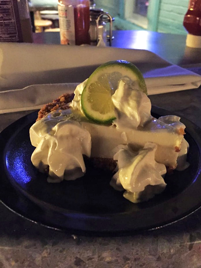Key lime pie in its natural habitat&mdash;about to disappear. That lime garnish is basically waving goodbye as your fork makes its inevitable approach.