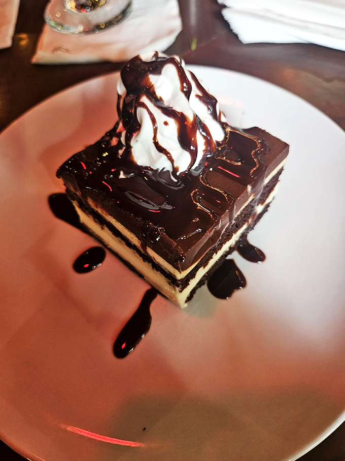 This isn't just chocolate cake&mdash;it's a layer cake autobiography with a whipped cream epilogue. The chocolate drizzle is just showing off at this point.