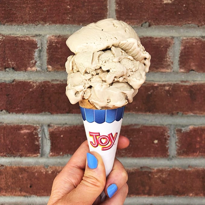 Ice cream cones should always wear their contents proudly, like this perfect scoop standing tall against a brick backdrop. The "Joy" cone name has never been more appropriate.