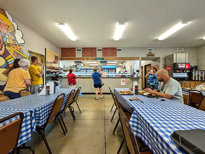 The dining room: where strangers become friends united by the universal language of "mmm" and "pass the napkins." Blue tablecloths set the stage for BBQ magic.