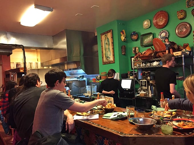 Happy diners gathered around a feast&mdash;the universal language of "mmm" needs no translation. This is what communal dining is all about.