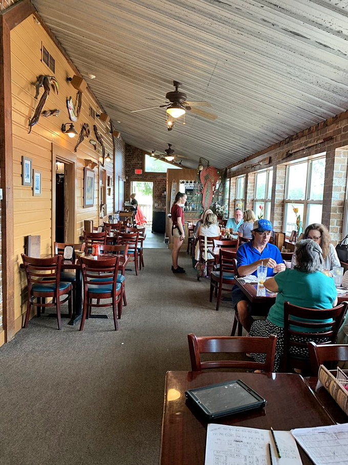 Inside the nautical-themed dining room, patrons enjoy meals beneath fishing memorabilia&mdash;a reminder of exactly where today's catch originated.