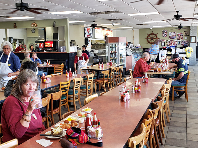 The bustling dining room where strangers become friends, united by the universal language of "pass the tartar sauce, please."