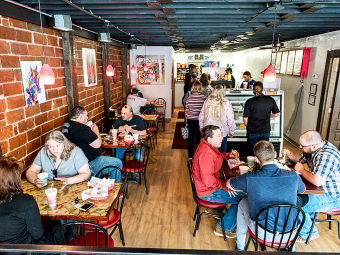 A full house of happy diners, each experiencing their own personal moment of sandwich bliss. The universal language of "mmm" needs no translation.
