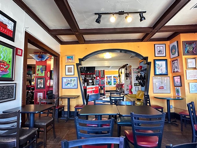 Sunshine-yellow walls frame the dining experience, where every table feels like the best seat in a house filled with art and anticipation.