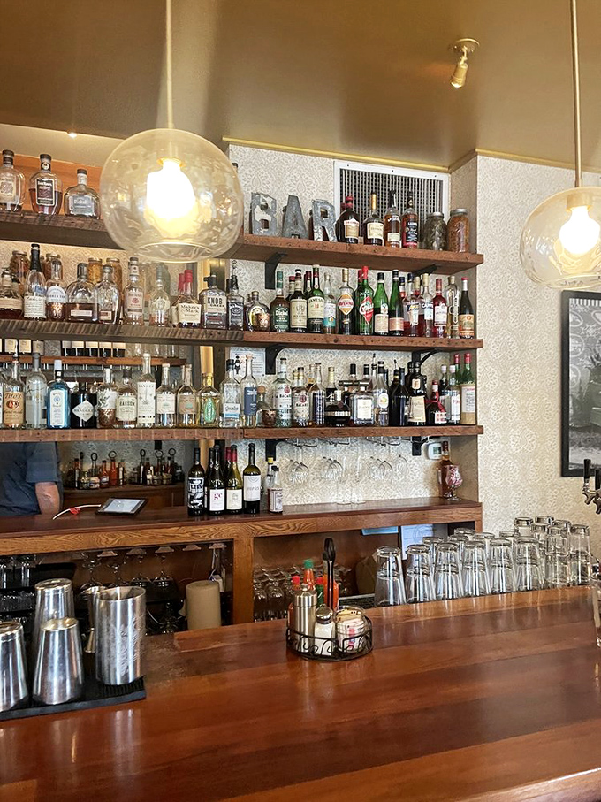 The bar shelves tell a story of carefully curated spirits&mdash;like a library where every book is guaranteed to improve your day.