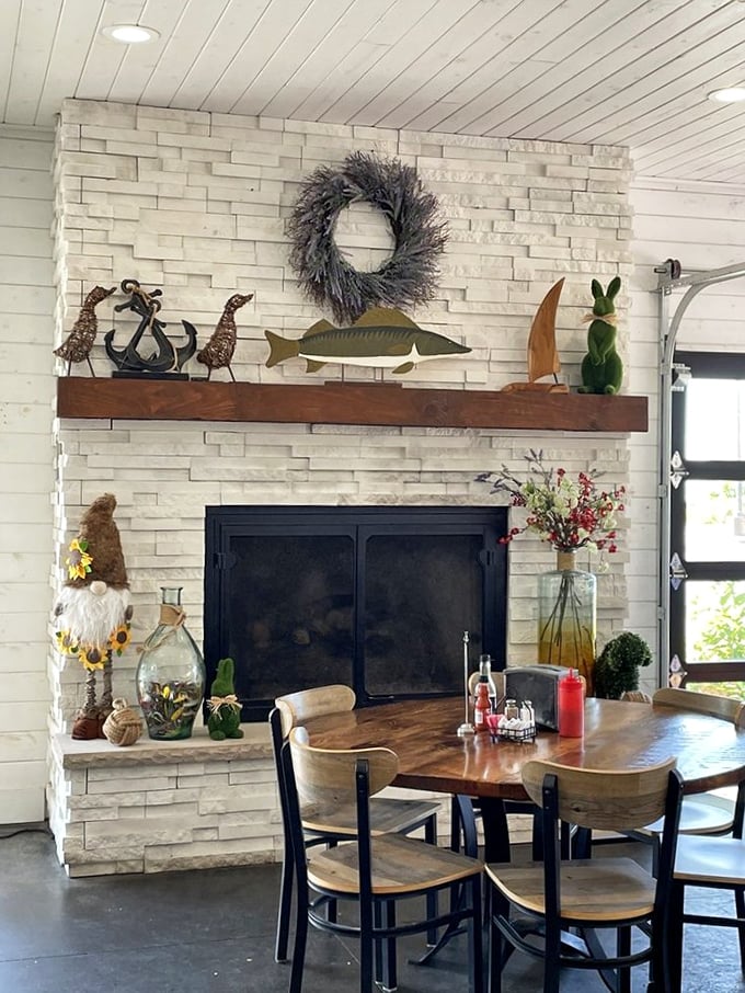 A cozy fireplace corner that makes winter seafood cravings even more satisfying. Nautical decor and warm flames&mdash;the perfect backdrop for comfort food.