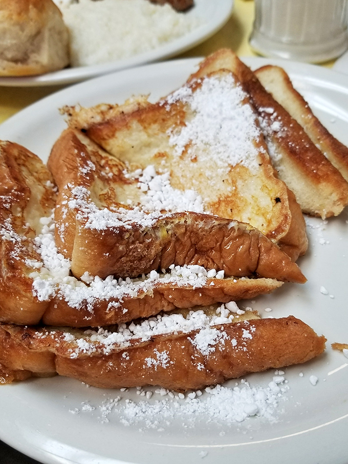 French toast that makes you question every pancake decision you've ever made. That powdered sugar isn't falling snow&mdash;it's breakfast confetti celebrating your wise choice.