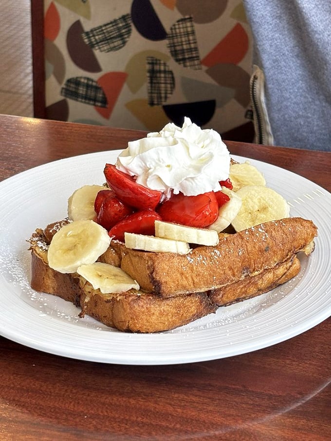 French toast that's dressed for success with strawberries, bananas, and enough whipped cream to make Monday morning feel like Saturday.