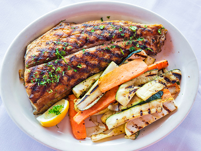 Blackened redfish with grilled vegetables&mdash;proof that not everything delicious at Nate's requires a deep fryer. Seasoned perfection on a plate.