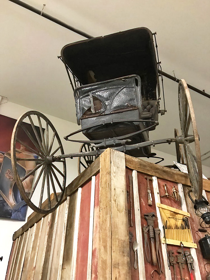 Before there were cars, there were carriages &ndash; this preserved wagon hangs as a reminder of transportation's evolutionary journey.
