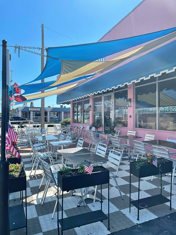 The outdoor patio, shaded by colorful canopies, offers al fresco dining with a side of Florida sunshine and gentle Gulf breezes.