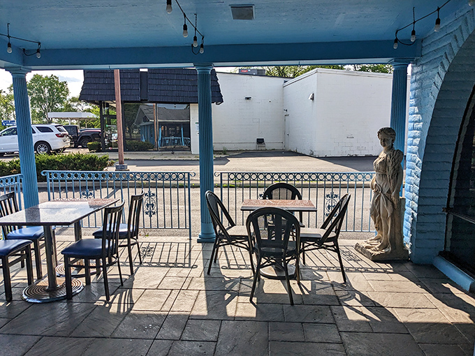 The outdoor dining area offers a blue-columned Greek escape. That classical statue isn't judging your third helping of baklava&mdash;she's impressed.