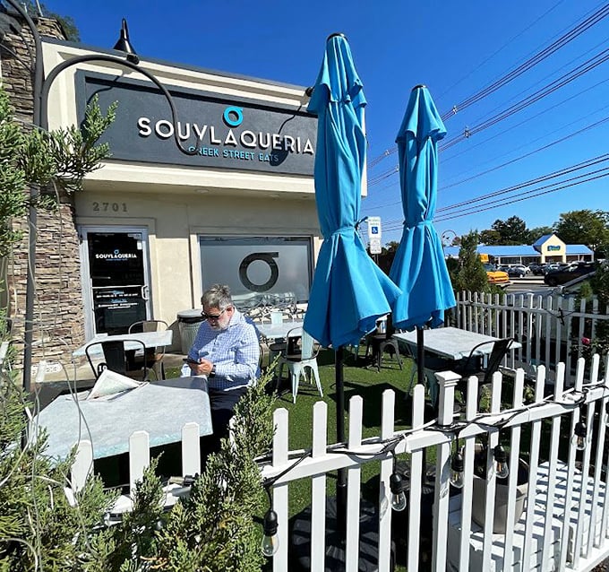 The outdoor dining area offers a slice of Mediterranean charm in suburban New Jersey&mdash;blue umbrellas and white fencing creating a mini-vacation with every bite.