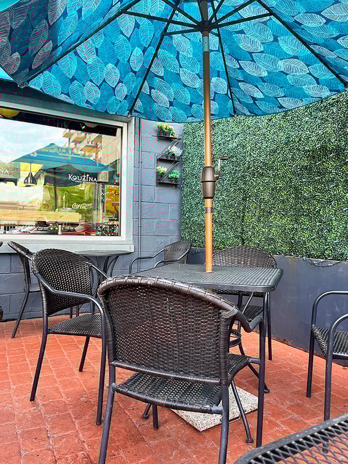 The outdoor patio &ndash; where Michigan weather and Mediterranean vibes occasionally align for perfect al fresco dining under that gorgeous blue umbrella.