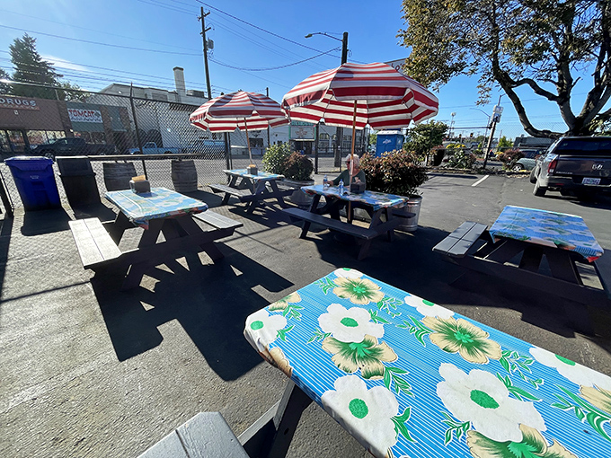 The outdoor dining area with its cheerful tablecloths and striped umbrellas—where summer barbecue memories are made under Portland skies.