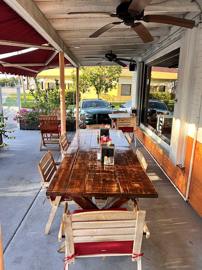 Outdoor dining that captures Florida's perfect weather moments. That wooden table has heard more good conversations than a therapist's couch.