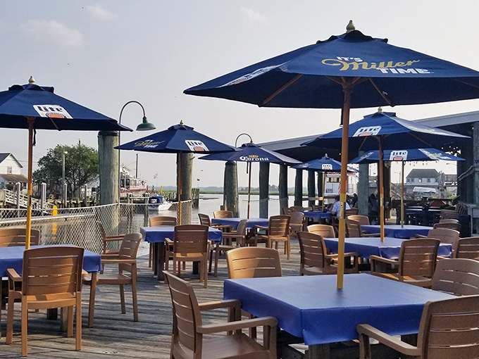 Dining al fresco under Miller Time umbrellas. The waterfront deck at JP's is where summer memories are made one blue table at a time.