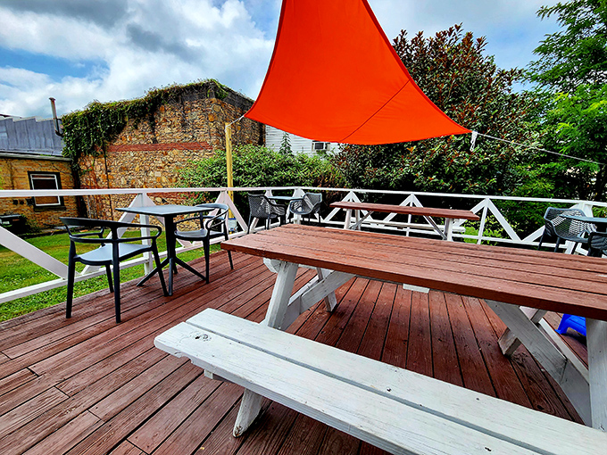 The outdoor dining deck&mdash;where fresh air makes everything taste better. That orange canopy provides just enough shade to keep your breakfast experience perfect.