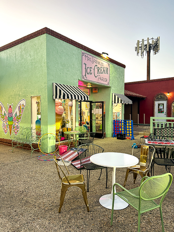As evening falls, the mint-green parlor glows like a beacon of sweetness. Outdoor seating awaits your ice cream dreams.
