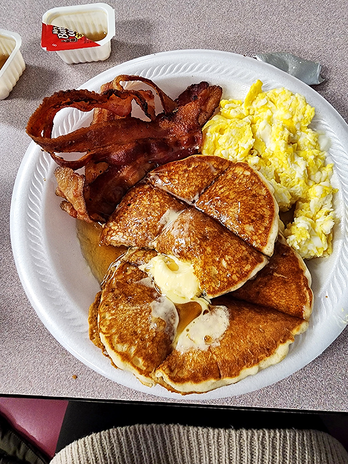 Pancakes so perfect they make maple syrup feel like it won the lottery. Those eggs and bacon aren't jealous&mdash;they're proud.