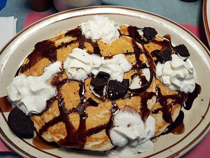Oreo pancakes topped with whipped cream and chocolate sauce. Because sometimes breakfast should feel like you're getting away with something.