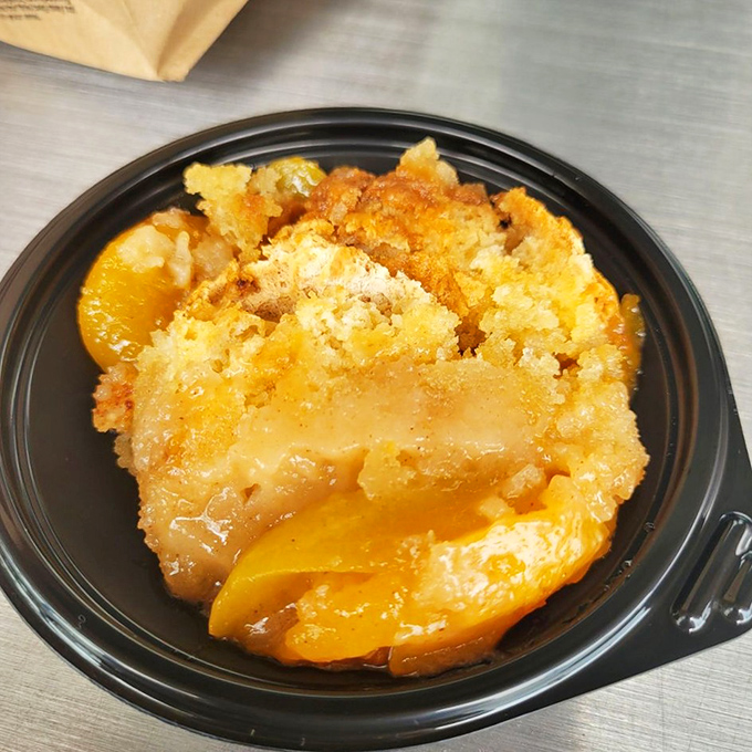 Peach cobbler that makes you question why you wasted stomach space on actual dinner. The perfect sweet finale to a smoky symphony.