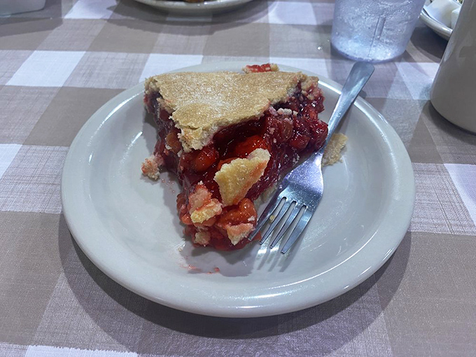 This slice of strawberry pie isn't just dessert; it's edible stained glass. The ruby-red filling gleams like jewels in a treasure chest.