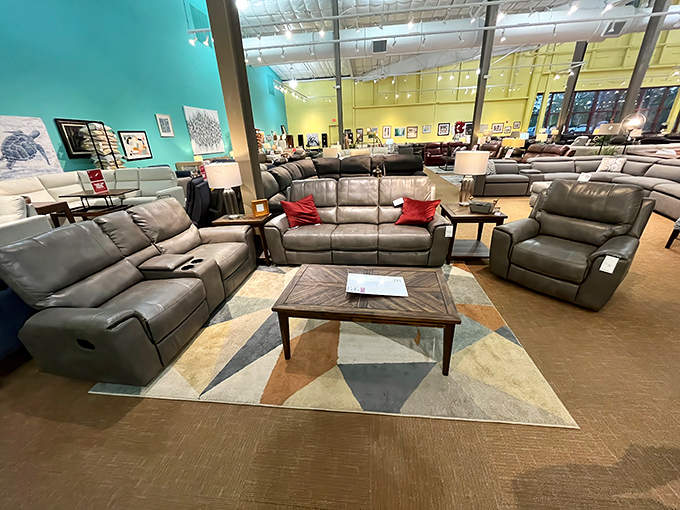 The geometric rug anchors this leather living room collection, creating an island of comfort in a sea of showroom options.