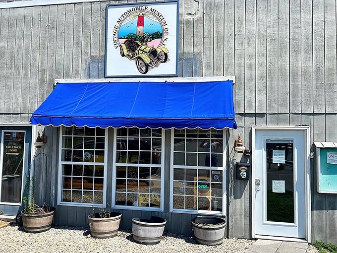 Summer brings a bright blue awning to welcome visitors, like a friendly wink from a building that knows exactly what treasures it's hiding inside.