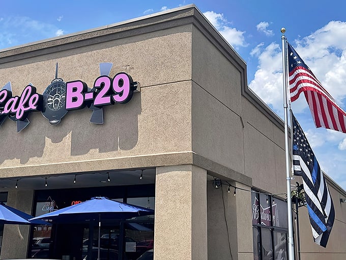 Cafe B-29 takes flight with its aviation-themed charm. That pink neon sign against the tan exterior is your runway to comfort food heaven.