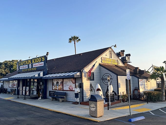 Captain Kidd's exterior stands like a salty sea captain's outpost, complete with shark statue standing guard. The perfect no-frills seafood adventure awaits!