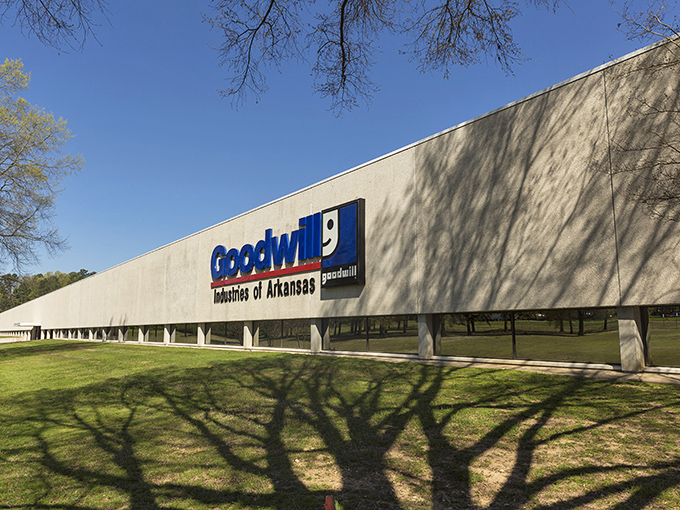 The mothership of secondhand treasures! Goodwill's Arkansas headquarters stands tall, casting tree shadows like nature's welcome mat for bargain hunters.