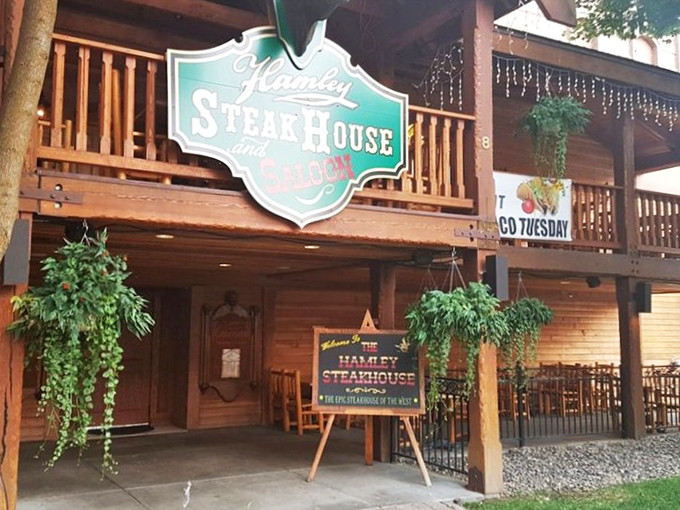 Cozy elegance meets cowboy charm! This dining room's warm wood and brick fireplace create the perfect backdrop for a steak that'll make you say "Yeehaw!" 
