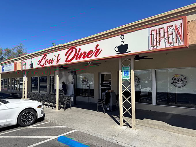 Lou's Diner beckons with that classic red signage – where breakfast dreams come true and coffee cups never run dry.