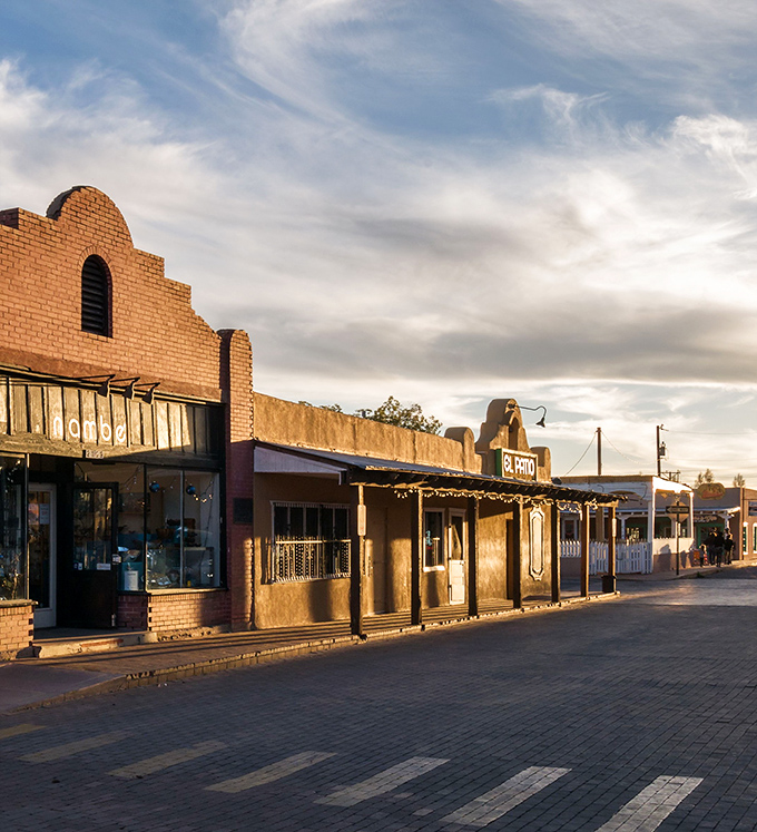 Historic adobe storefronts in Mesilla's plaza catch the golden hour light, like a southwestern postcard come to life.