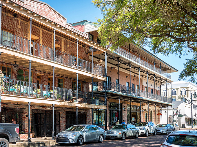 Historic brick buildings with wrought-iron balconies line Natchitoches' Front Street, like a time machine set to "Southern charm."