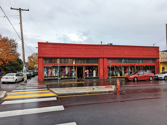 The bright red facade of Red Light Clothing Exchange stands out like a fashion beacon on Portland's Hawthorne Boulevard, promising vintage treasures inside. 