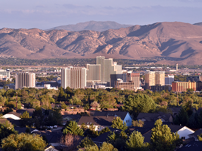 Reno's skyline nestled against the Sierra Nevada mountains &ndash; where affordable living meets breathtaking natural beauty.